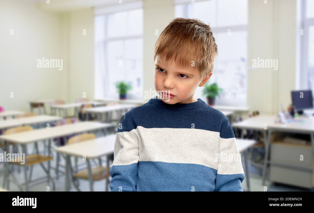 portrait of gloomy little boy at school Stock Photo - Alamy