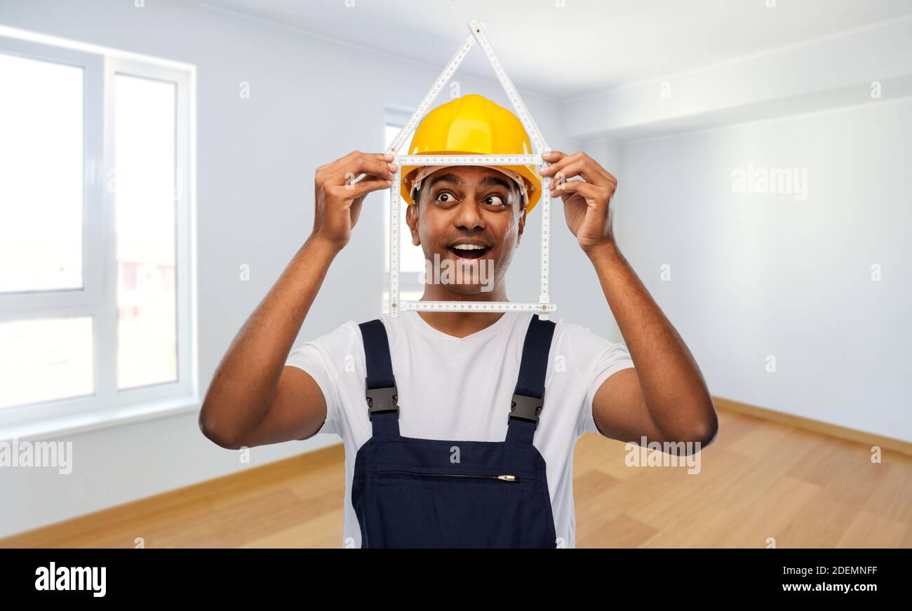 happy indian builder with ruler in shape of home Stock Photo - Alamy