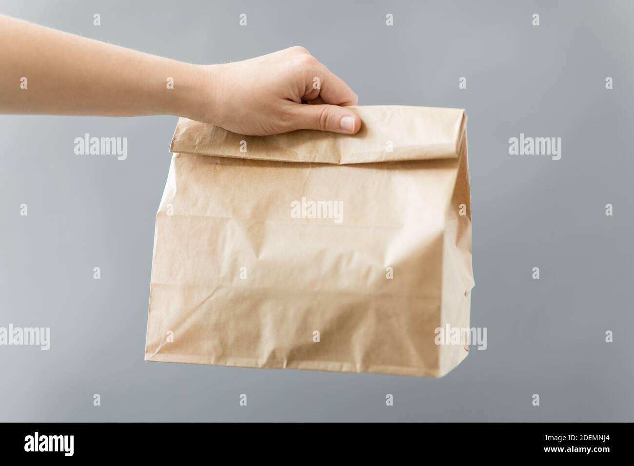 hand holding takeaway food in paper bag with lunch Stock Photo - Alamy
