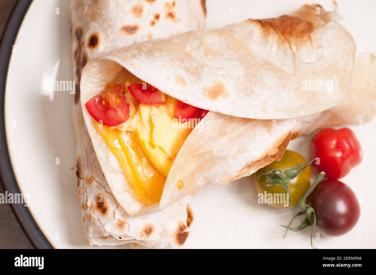 breakfast burrito with cheese, eggs and heirloom cherry tomato Stock ...