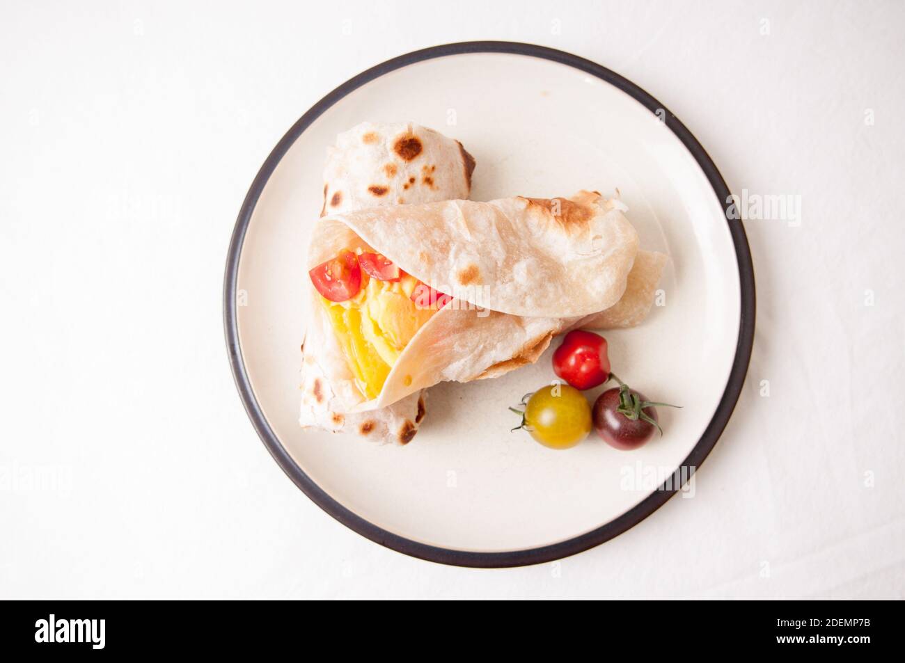 breakfast burrito with cheese, eggs and heirloom cherry tomato Stock ...