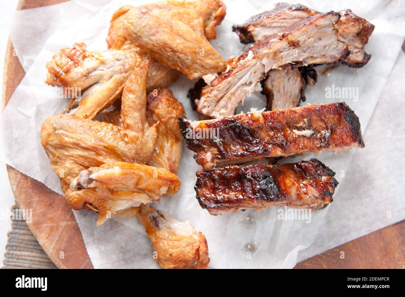 juicy barbeque pork ribs and dry chicken wings with glaze and hot sauce ...
