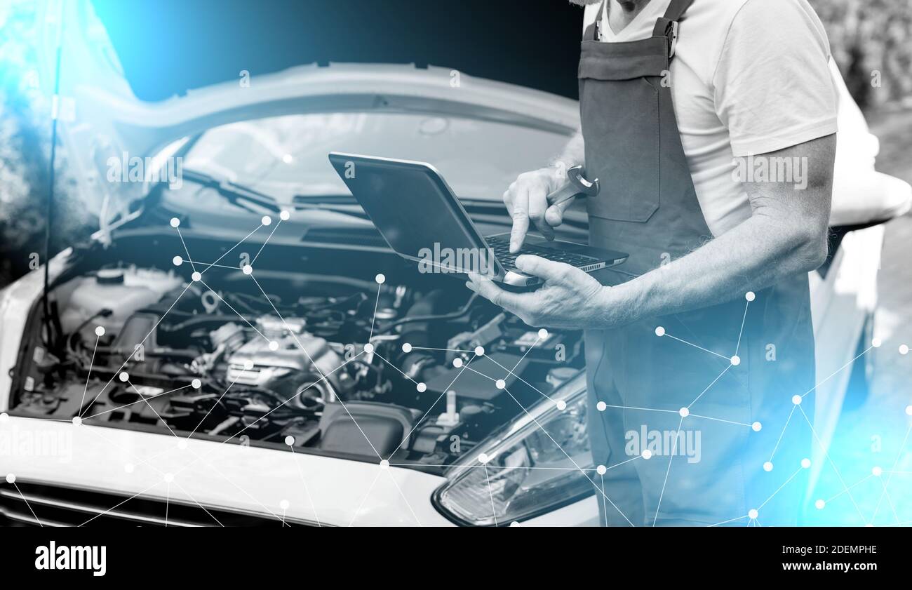 Car mechanic using laptop for checking car engine; light effect Stock ...