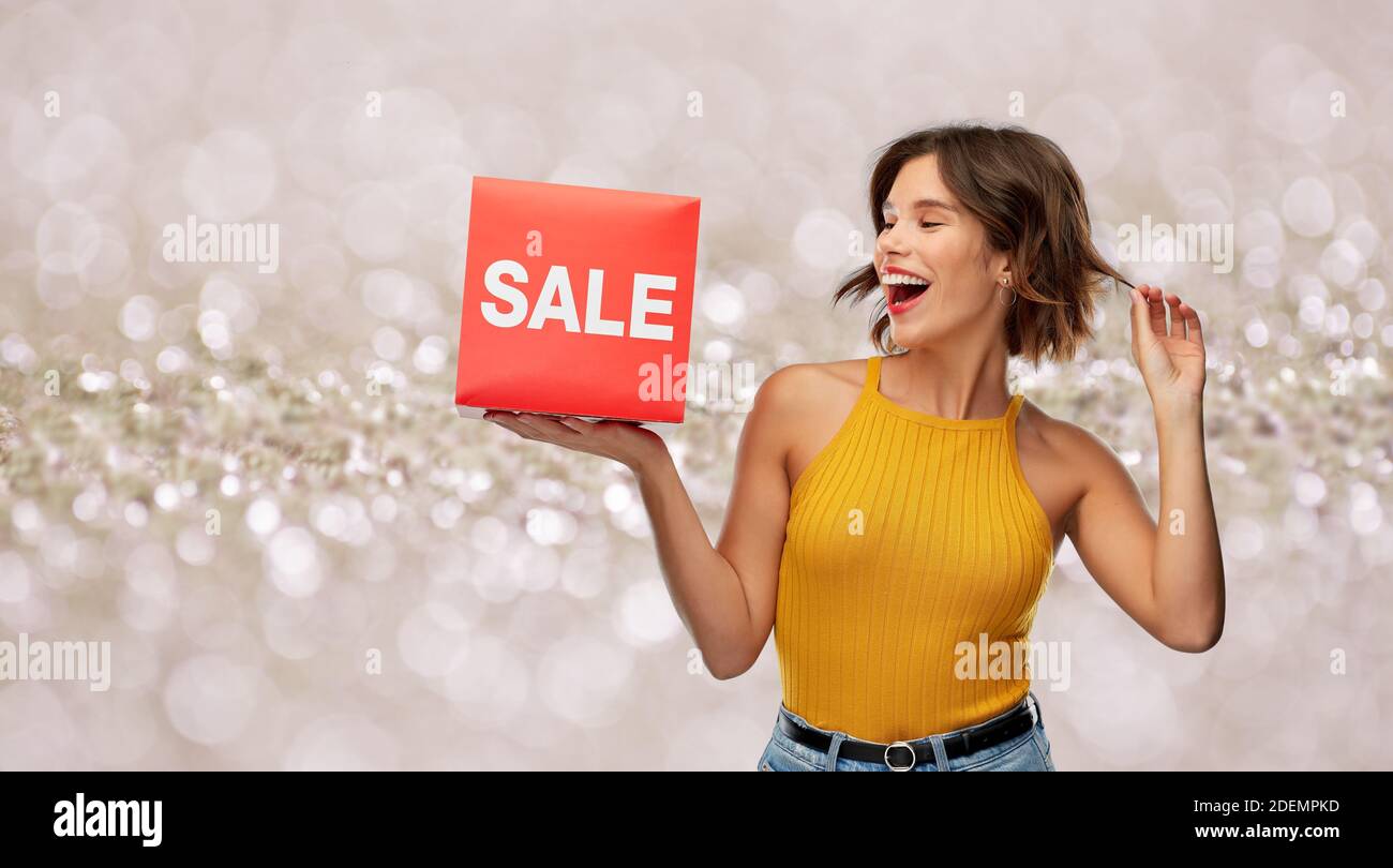 happy smiling young woman posing with sale sign Stock Photo - Alamy