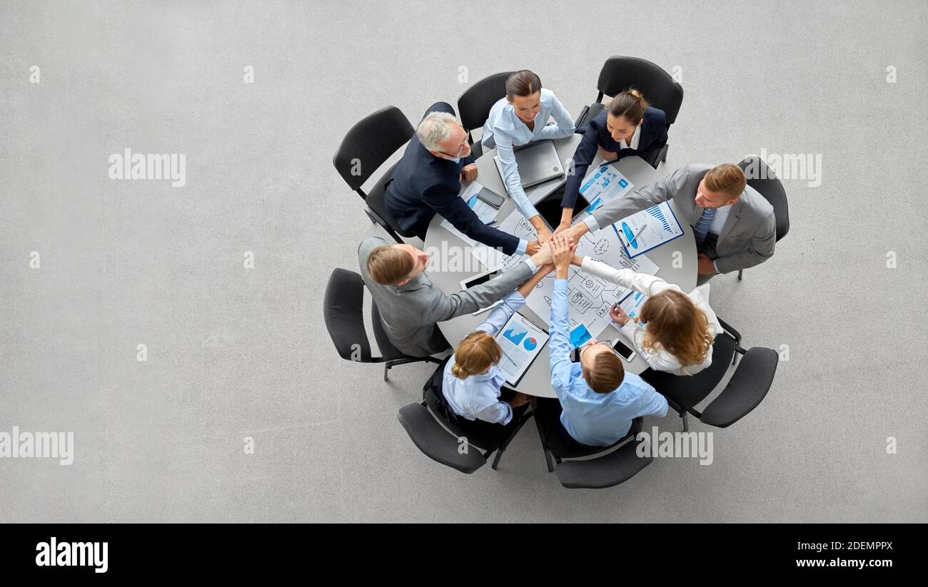 happy business people stacking hands Stock Photo - Alamy