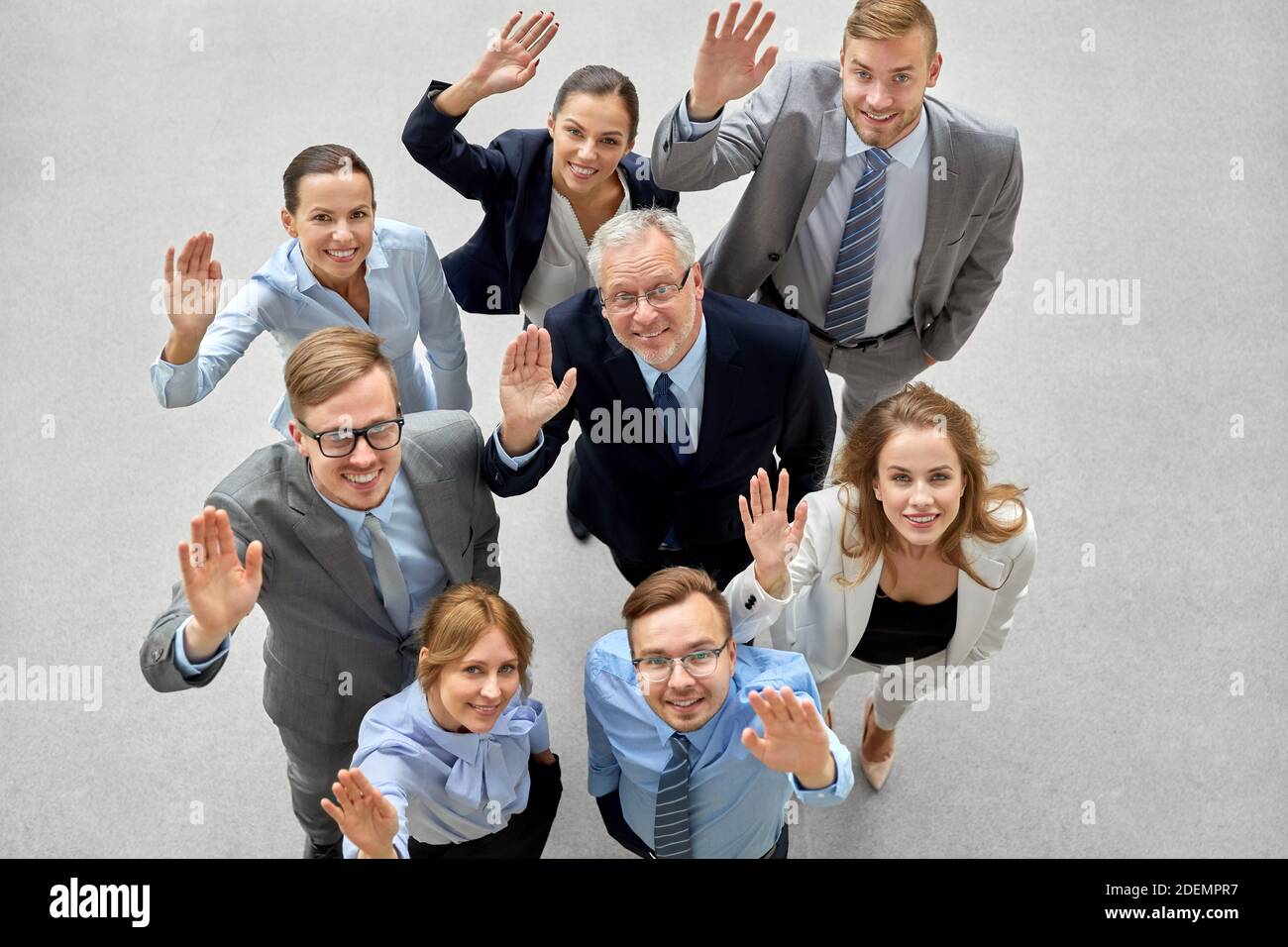 happy smiling business people waving hands Stock Photo - Alamy