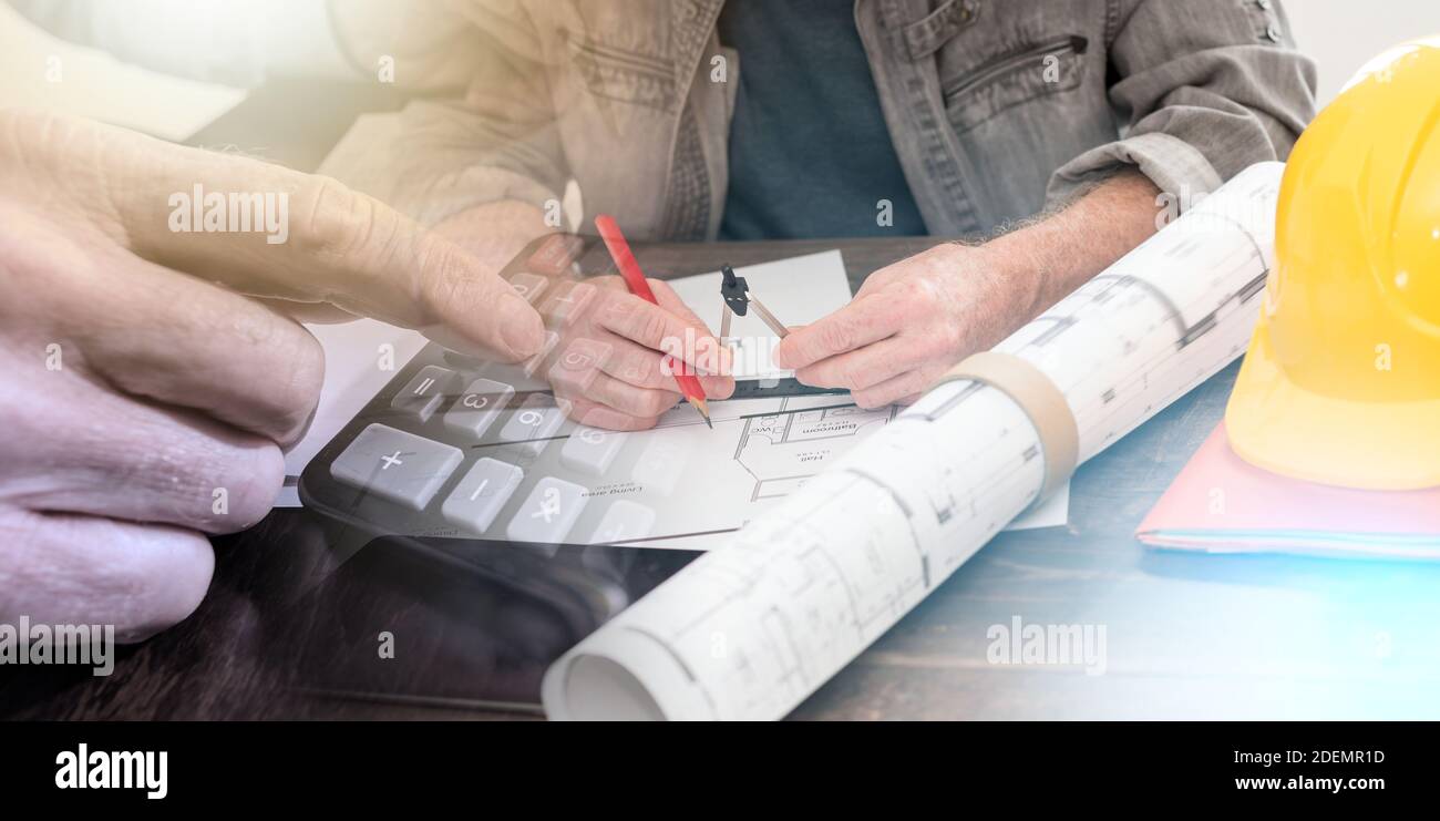 Architect working on plans at office, light effect; multiple exposure ...