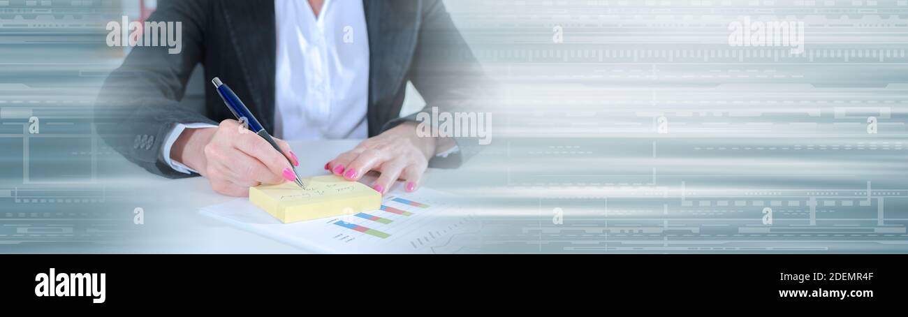 Businesswoman taking notes on a post-it; panoramic banner Stock Photo ...
