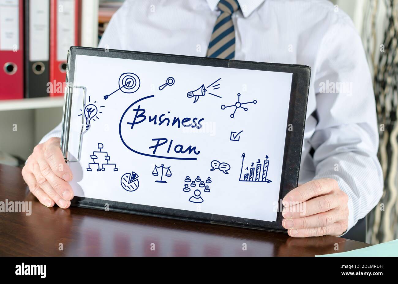 Business plan concept shown by a businessman Stock Photo - Alamy