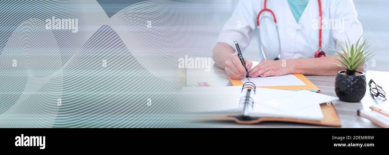 Female doctor writing a medical prescription in office; panoramic ...