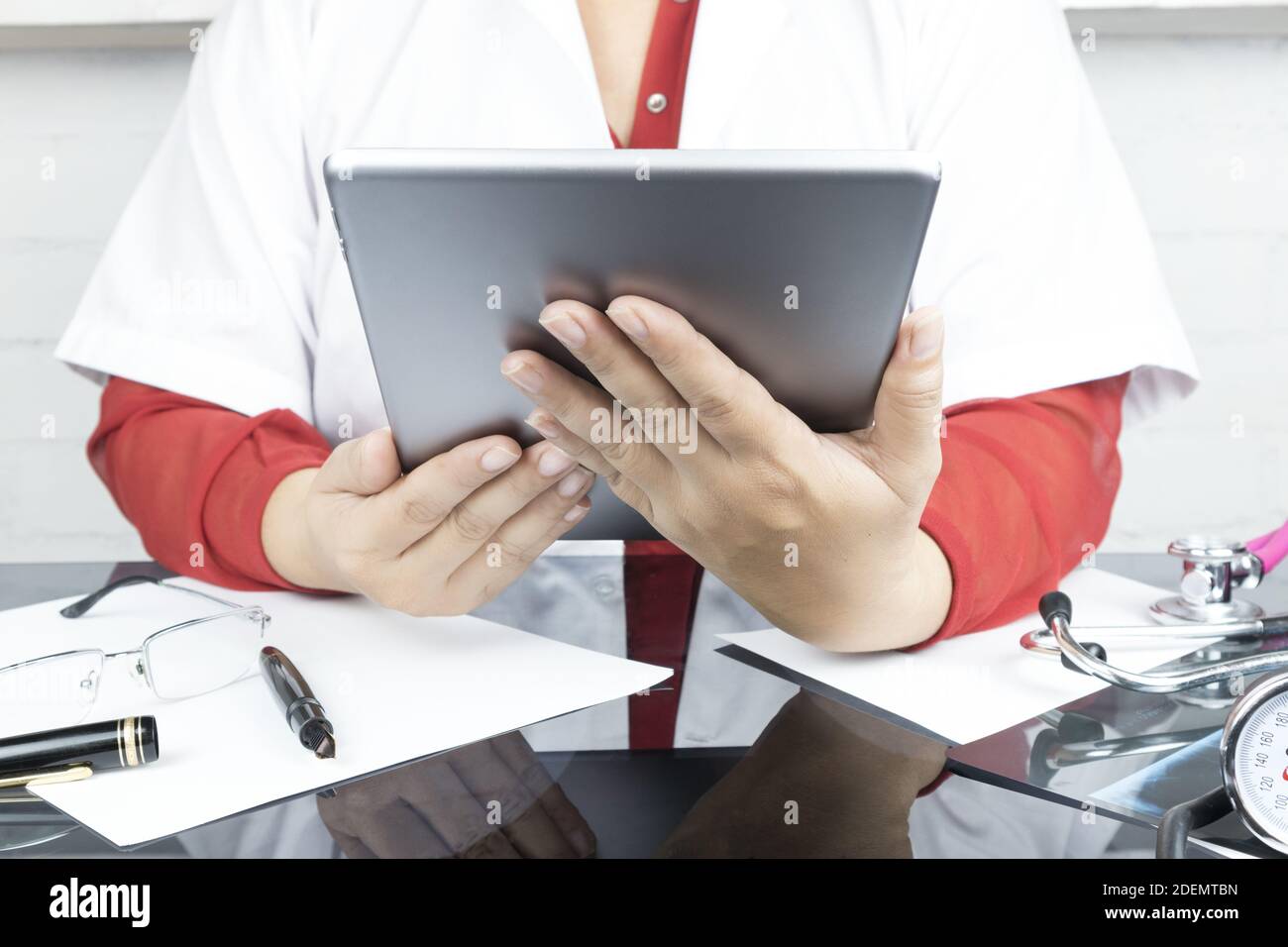 Doctor attending medical consultation, prescribing and delivering ...