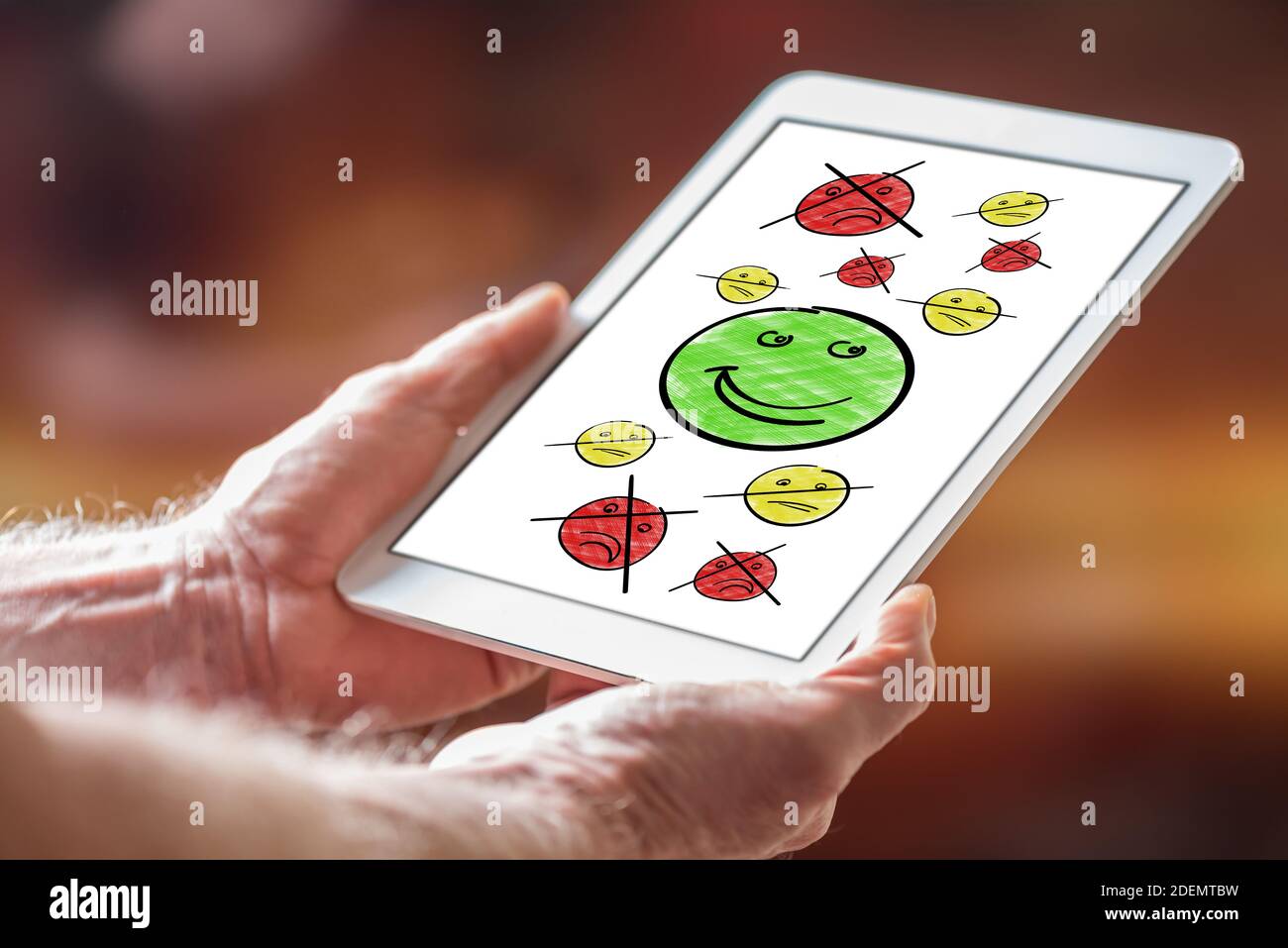 Man holding a tablet showing customer satisfaction concept Stock Photo ...