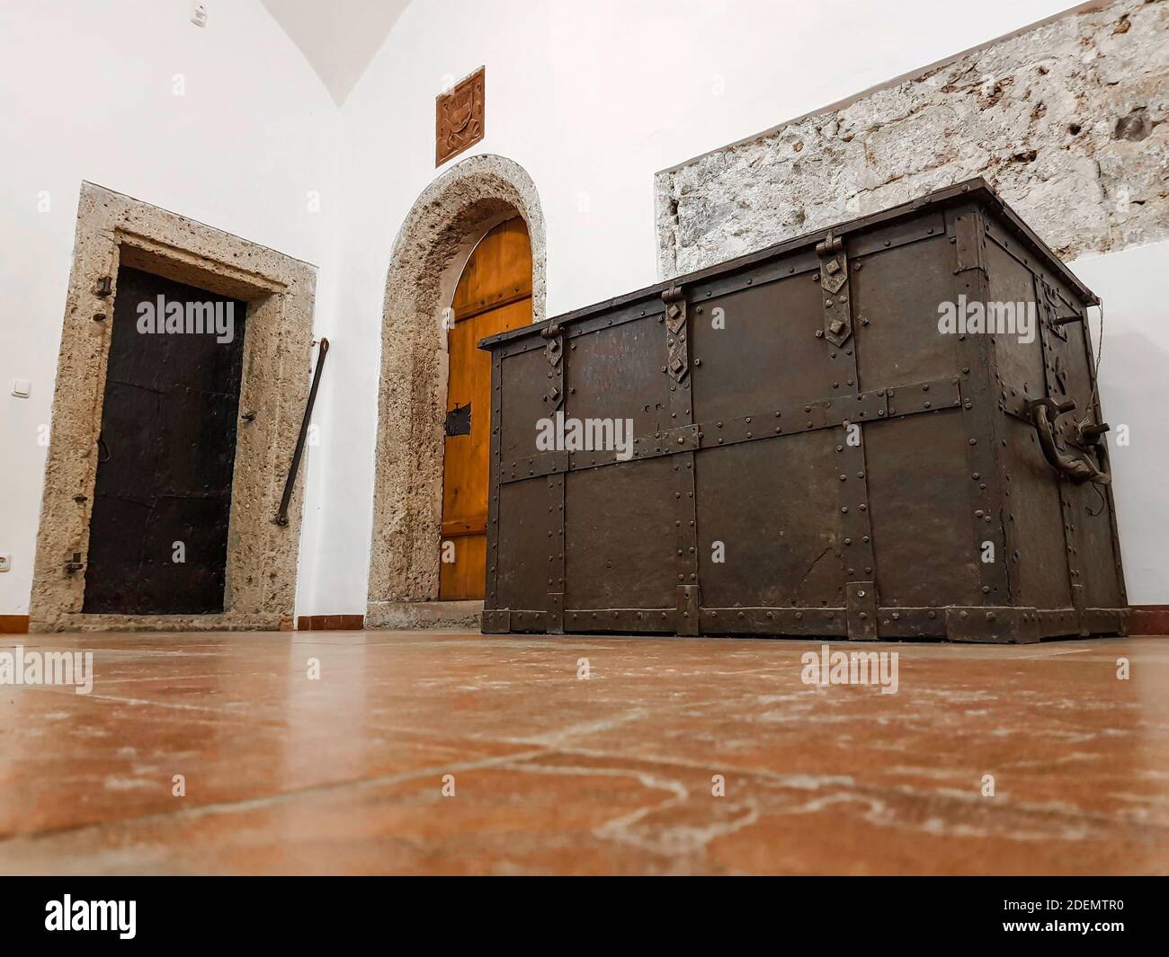 Beautiful old room with a metal chest on the floor with ornaments in a ...