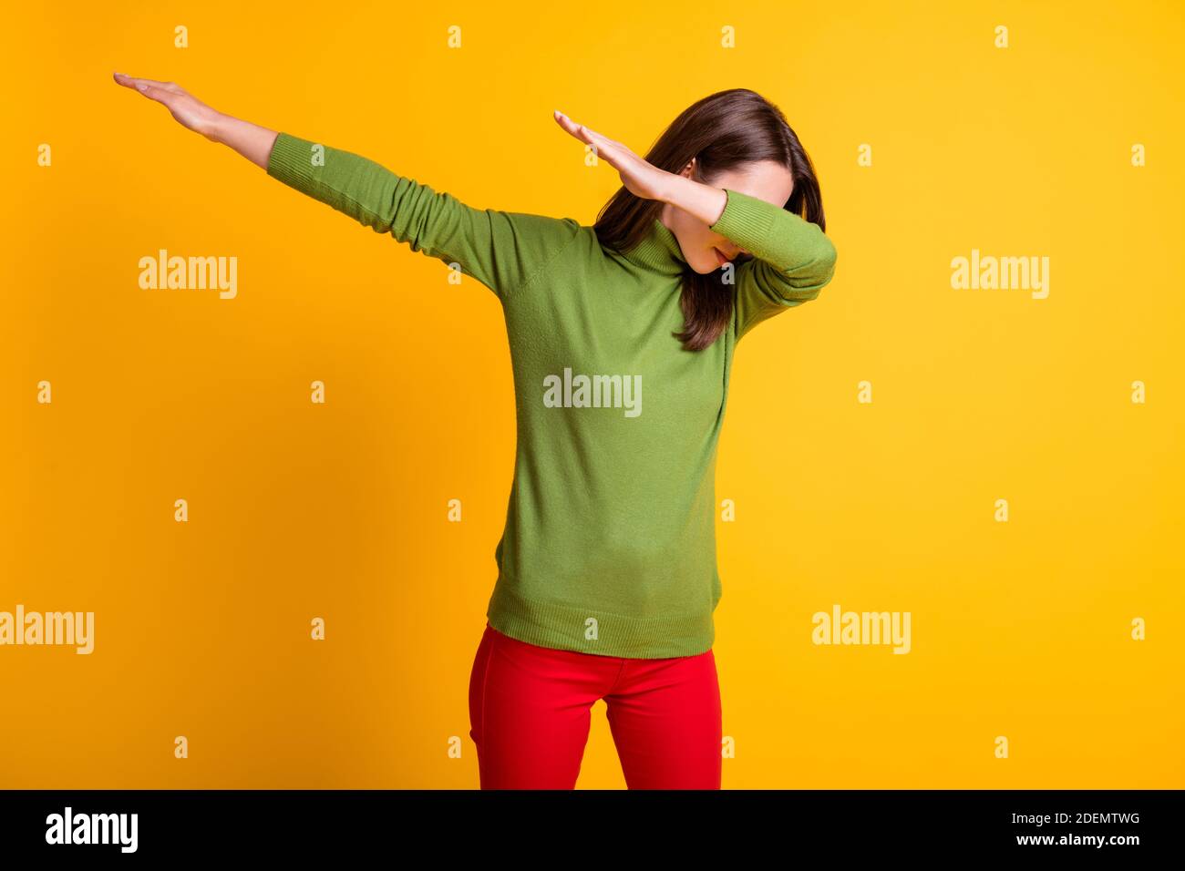 Portrait of attractive thin funky girl clubber dancing showing dab move ...