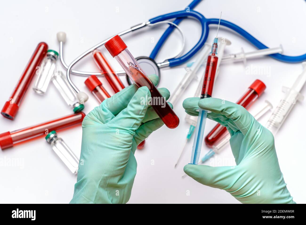 lab technician assistant holding syringe and test tube over light grey ...