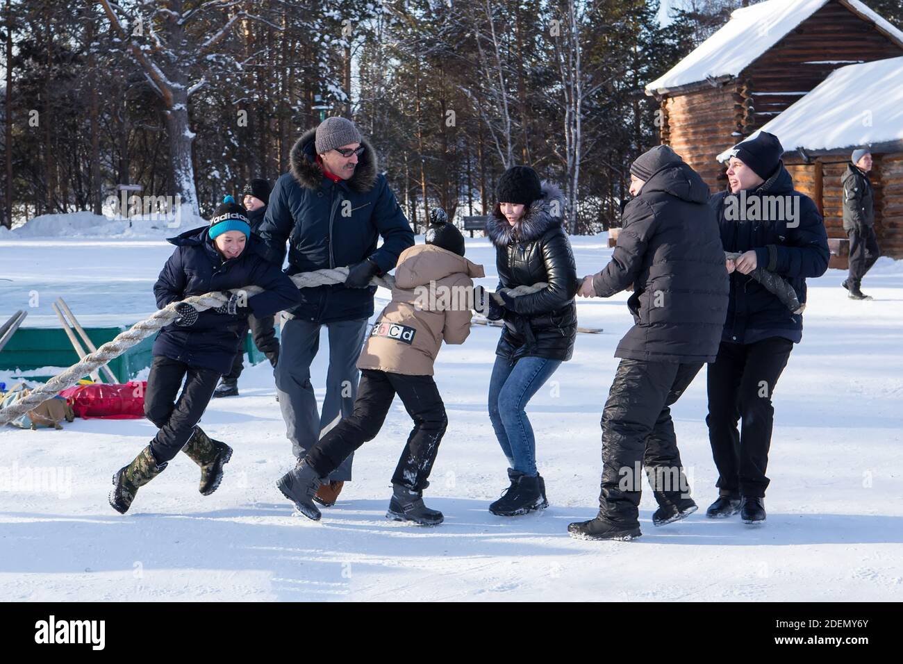 Irkutsk, Russia- 8 January 2019: Happy people having fun playing tug-of ...