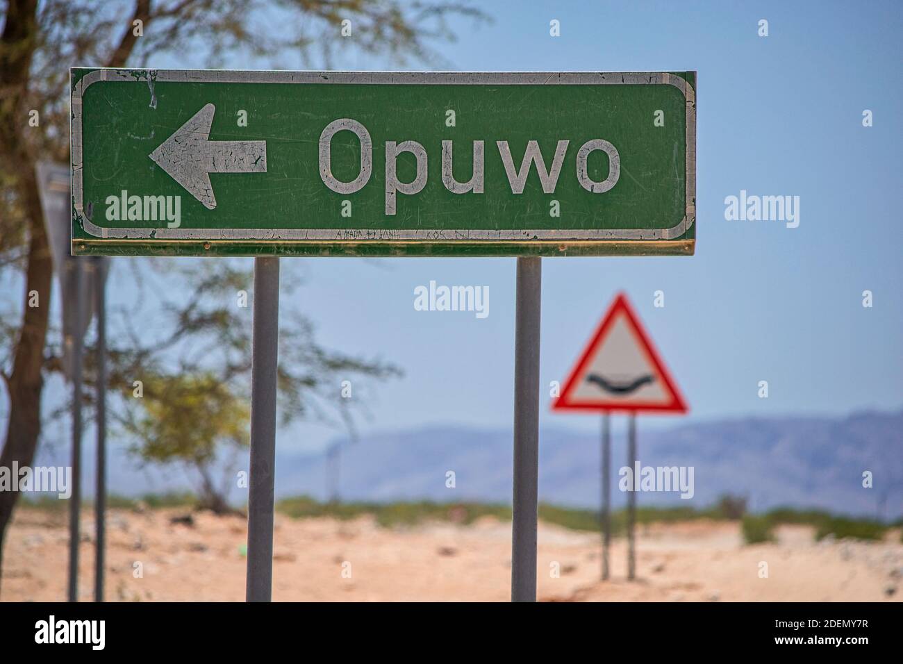 Green directional road sign to the city of Opuwo in Namibia, Africa ...