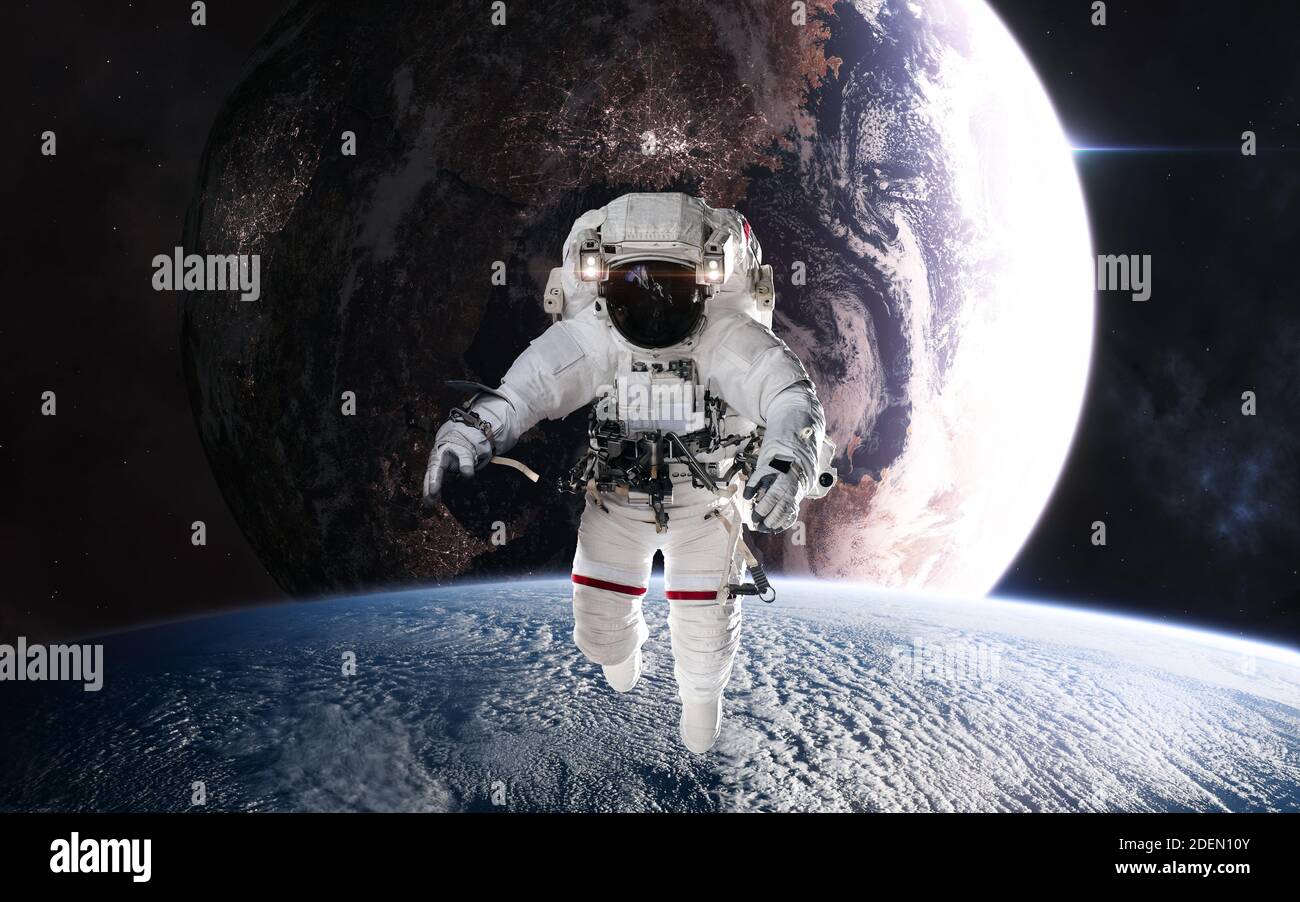Astronaut in outer space in planetary orbit. Inhabited planet in deep ...