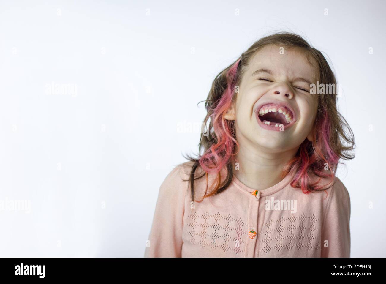 Adorable little kid girl laughing on a white Stock Photo - Alamy