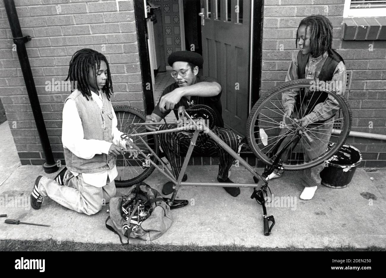 Father mending son's bicycle, UK 1990s Stock Photo - Alamy