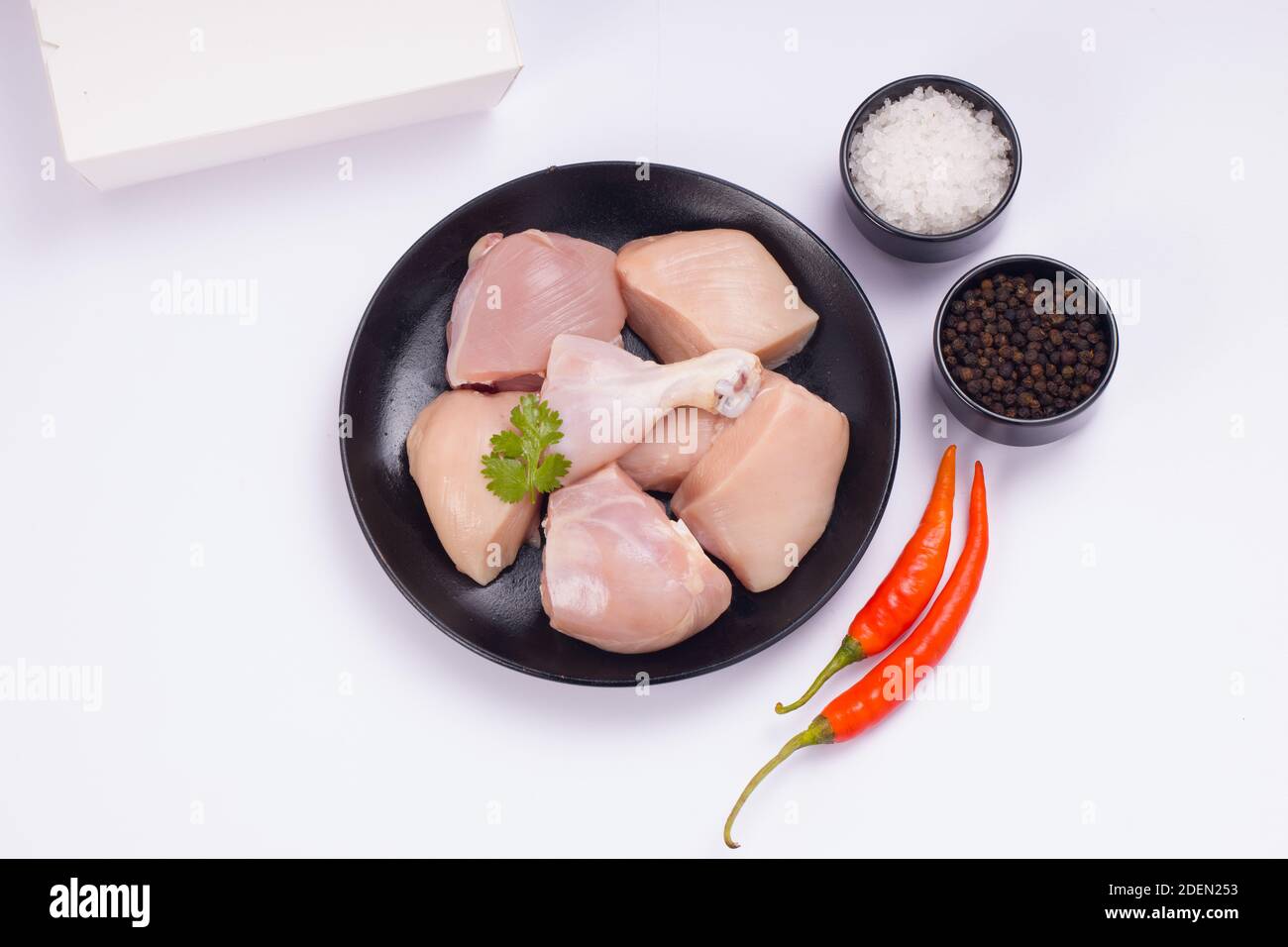 Raw chicken tender curry cut without skin arranged on black plate and ...