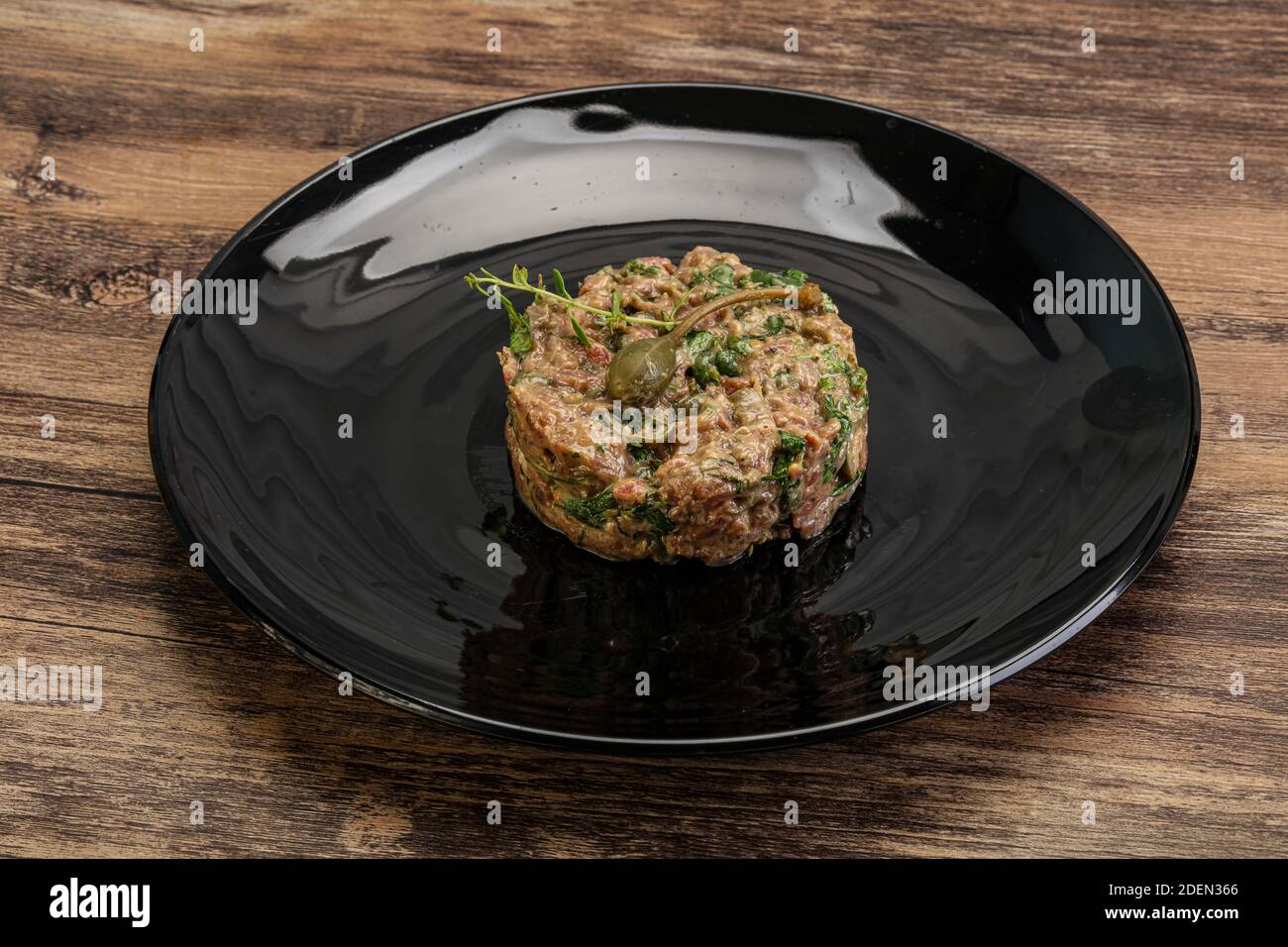 Raw beef tartar snack with capers Stock Photo - Alamy