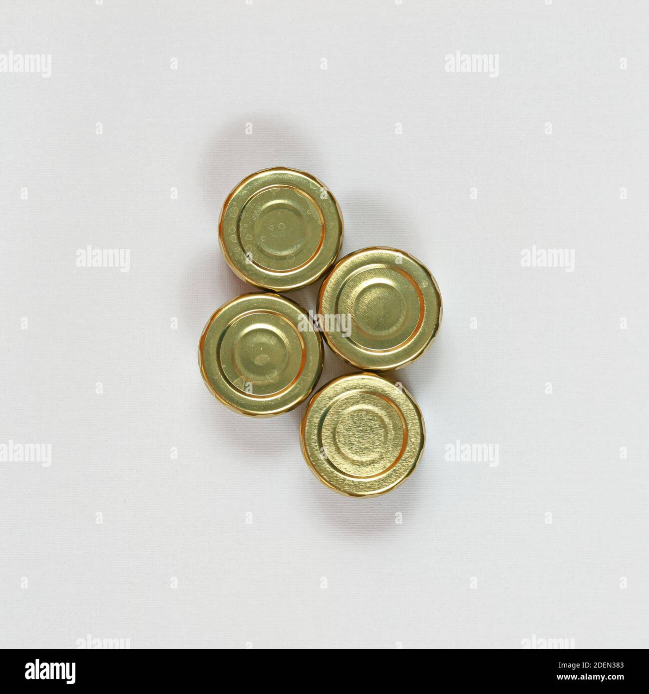 Four Small Jars With Golden Lids Top View Stock Photo - Alamy