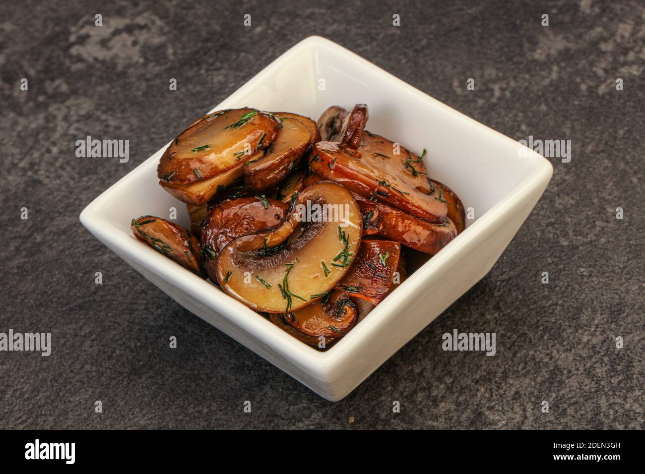 Roasted champignon with herbs and spices in the bowl Stock Photo - Alamy
