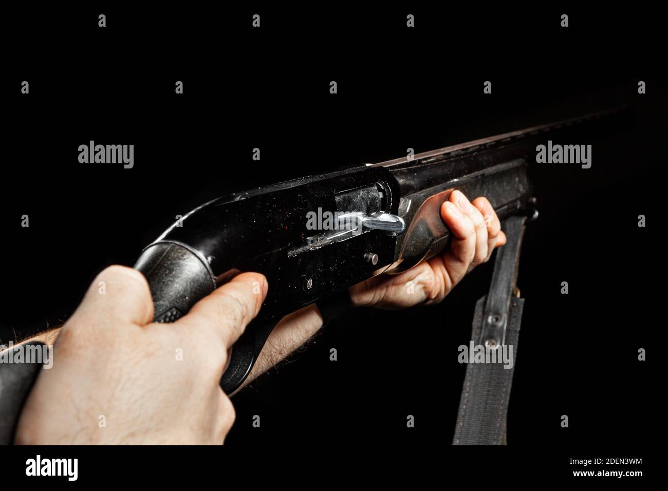 Male hands holding hunting rifle on black background Stock Photo - Alamy
