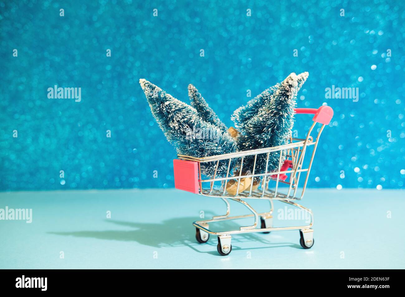 Christmas minimal festive background with toy trees in a supermarket ...