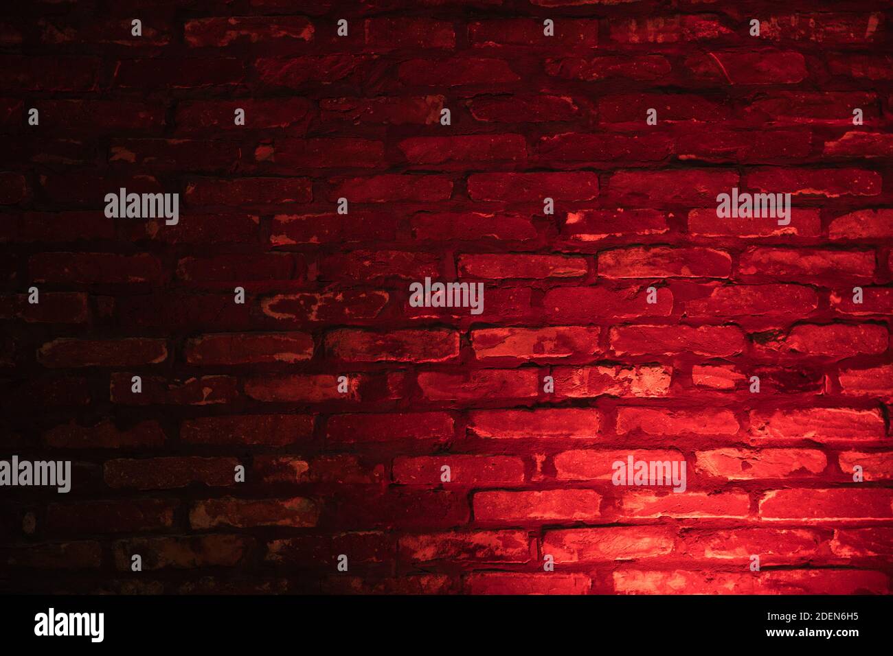 Old brick wall with bright red neon glow effect as background texture ...