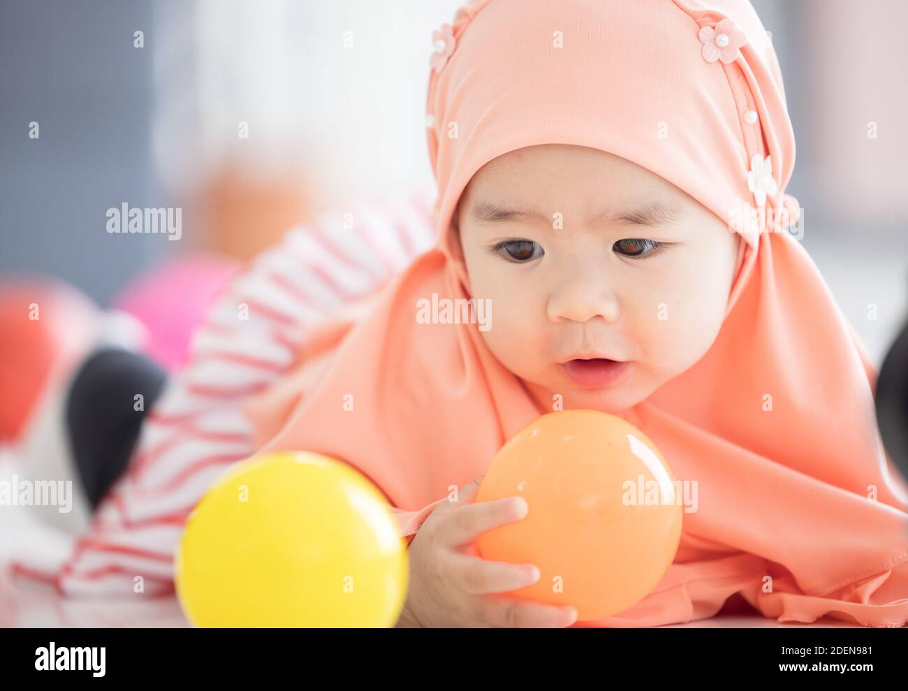 Muslim Baby plays with colorful toys in the living room Stock Photo - Alamy