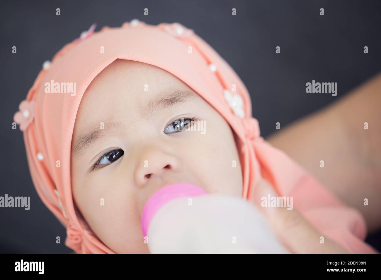 Muslim mother feeding her baby with bottle of milk Stock Photo - Alamy