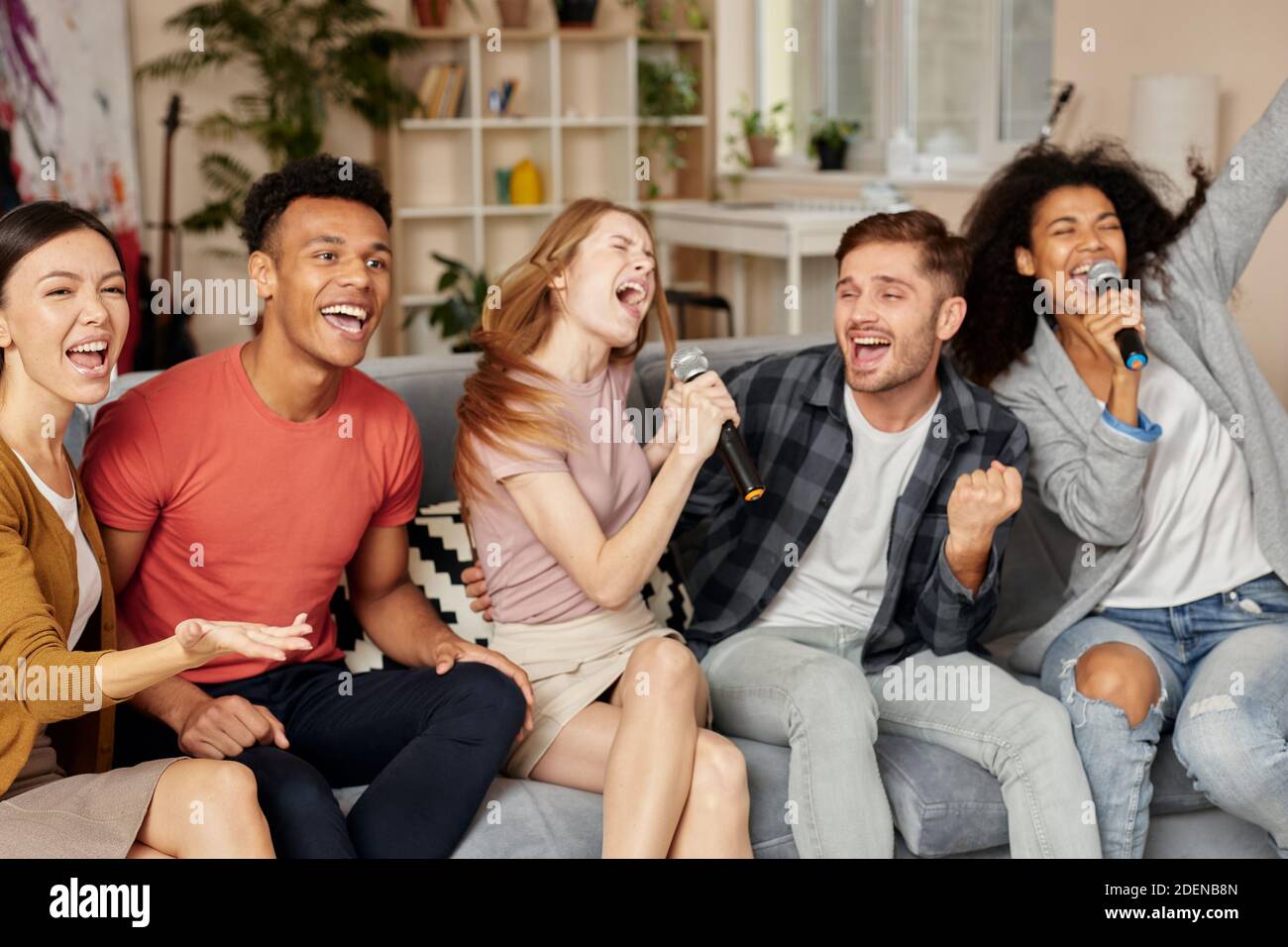 Moments filled with music. Excited young multicultural friends playing ...