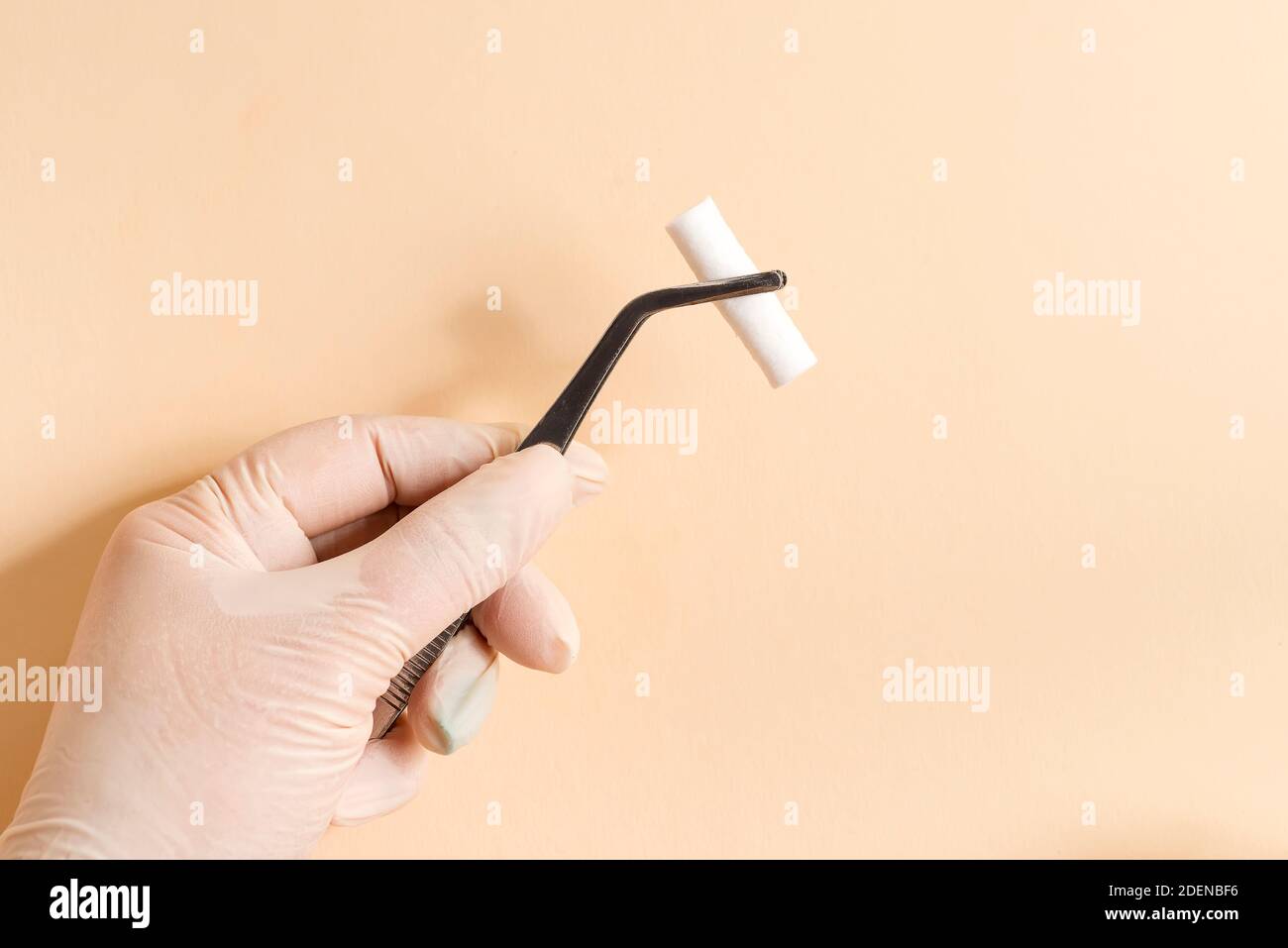 White swab clamped in metal surgical forceps. Accessories for doctors ...