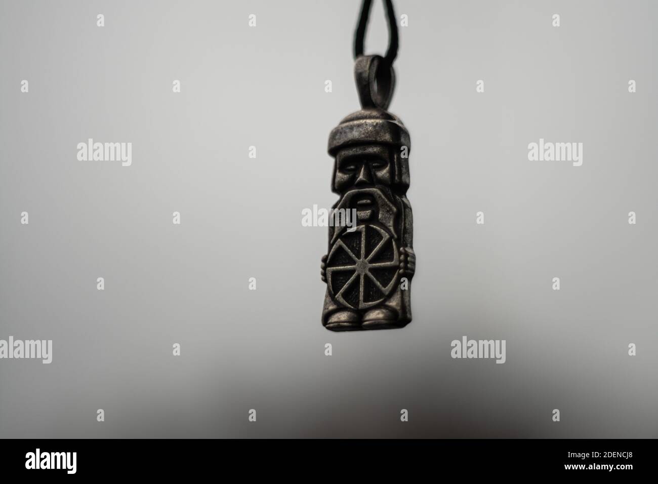 A Domovoi or Domowik silver pendant on the gray background, a house ...