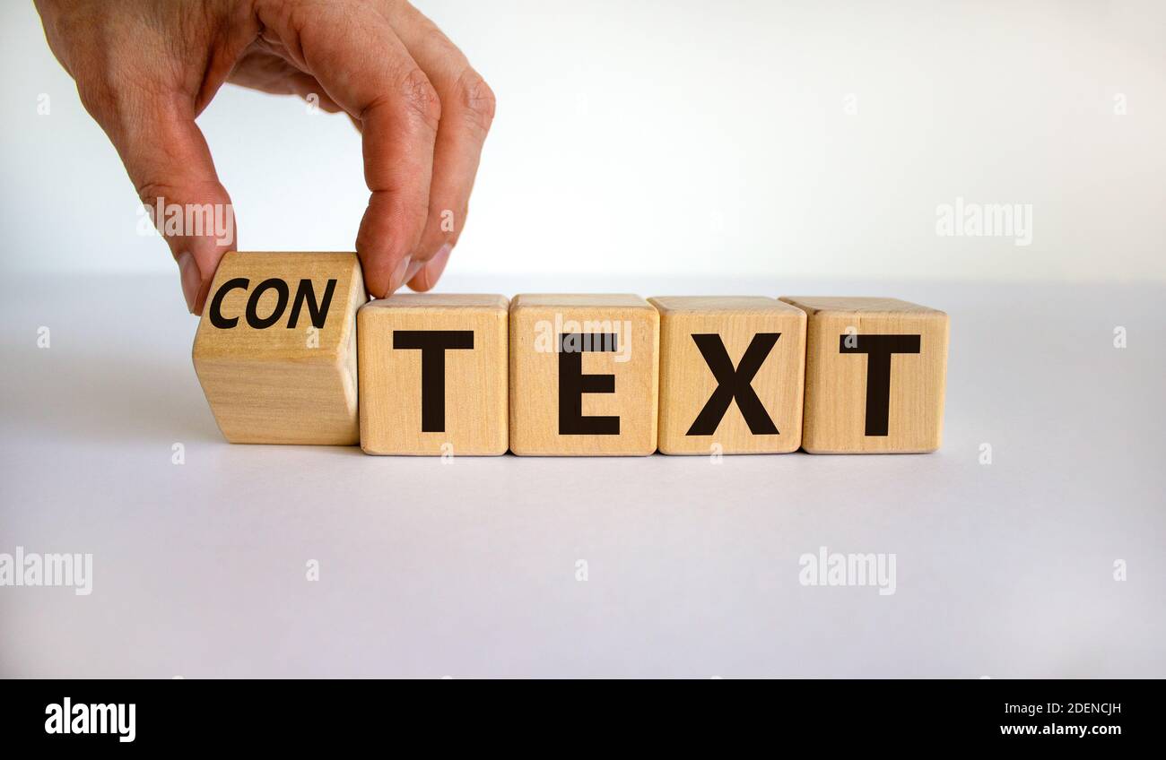 Text in context symbol. Male hand turns wooden cube and changes the ...