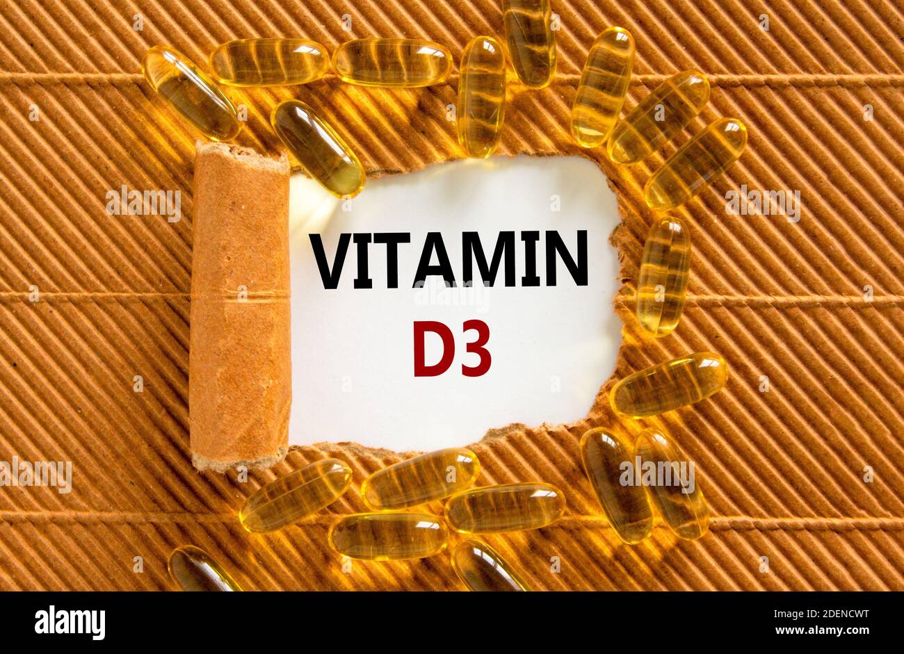 Vitamin D3 symbol. The word 'vitamin D3' appearing behind torn brown ...
