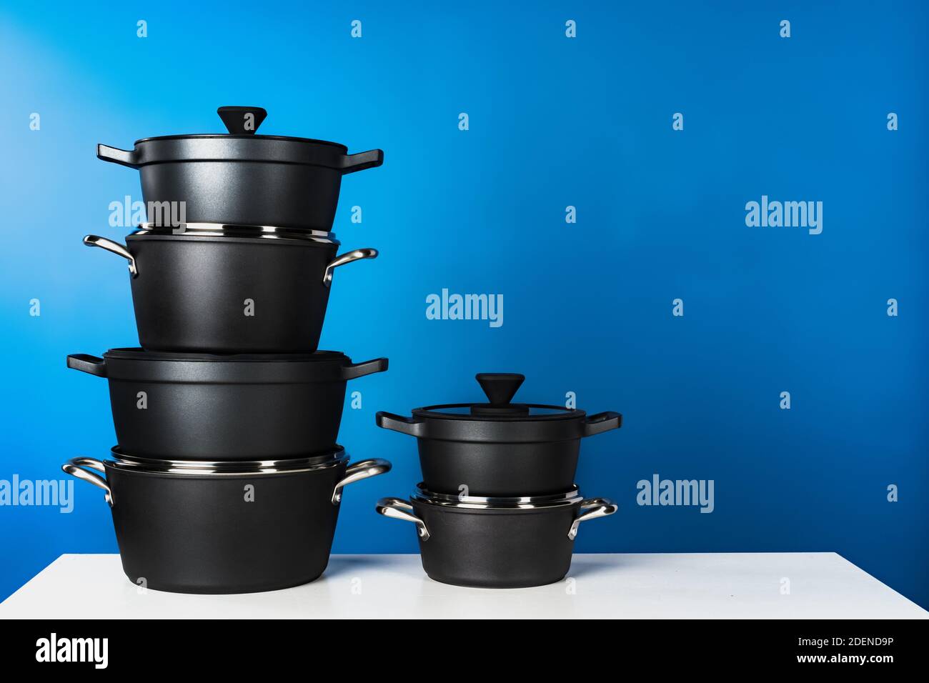 Set of black cookware against blue background Stock Photo - Alamy