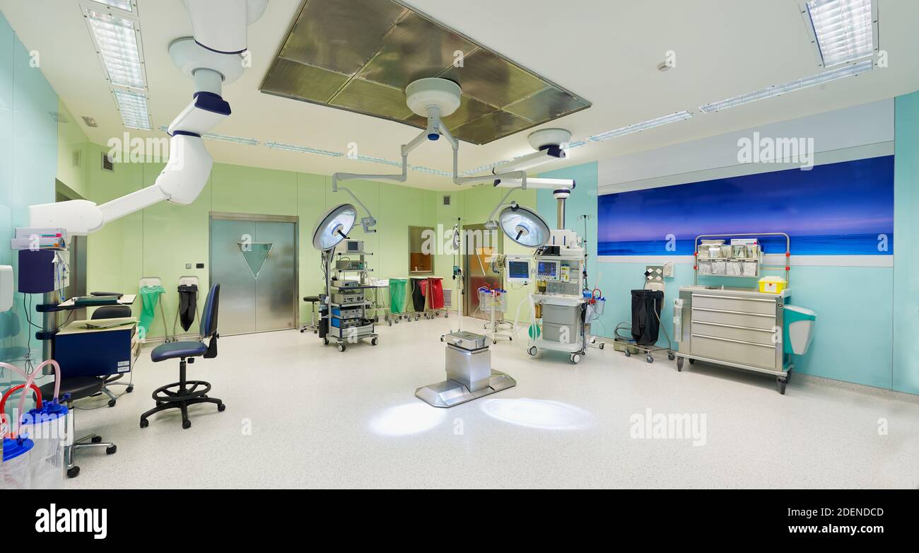 Hospital operating room, with overhead surgical lights, and may have ...