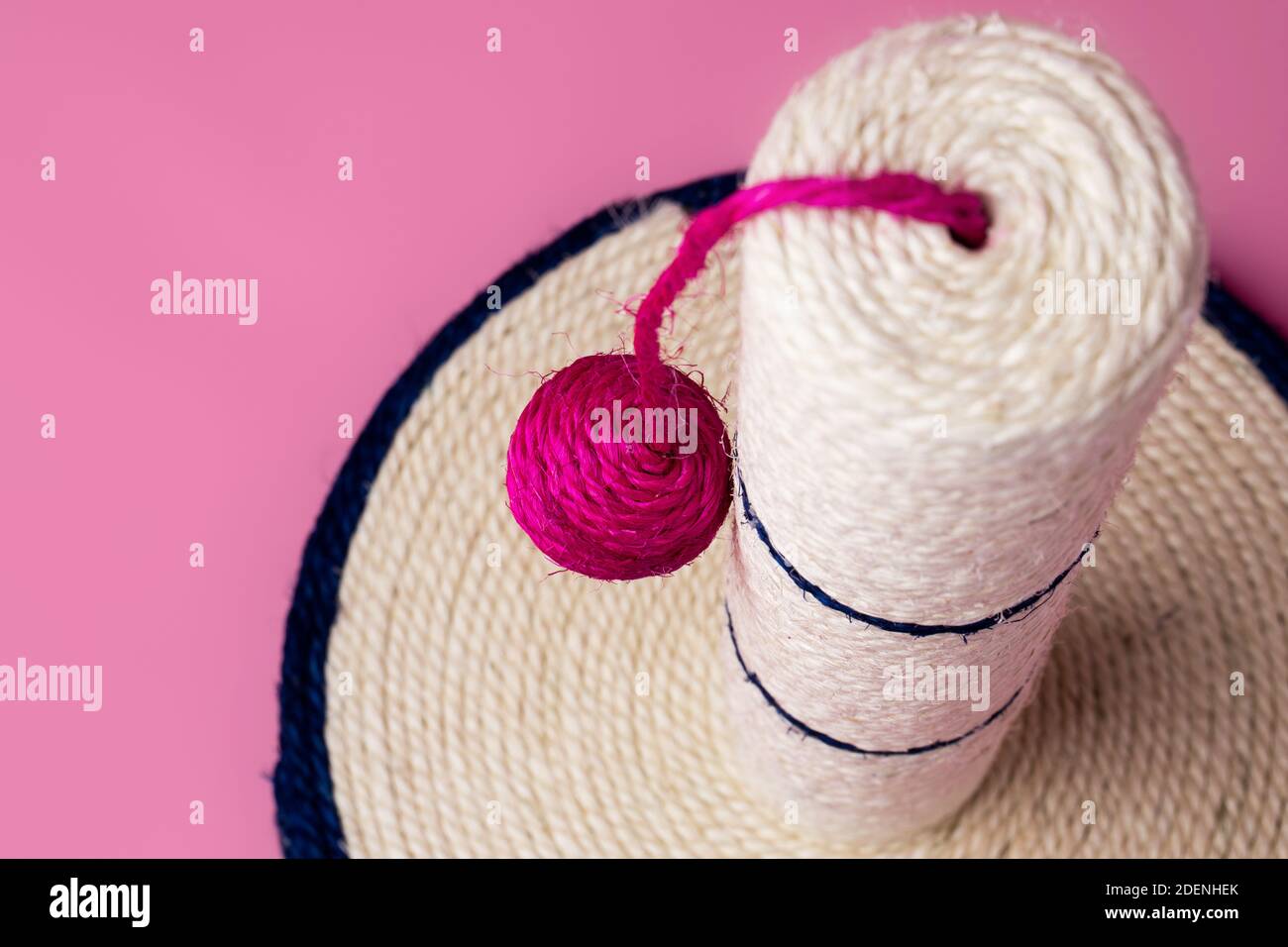 Scratching post for cats on pink background Stock Photo - Alamy