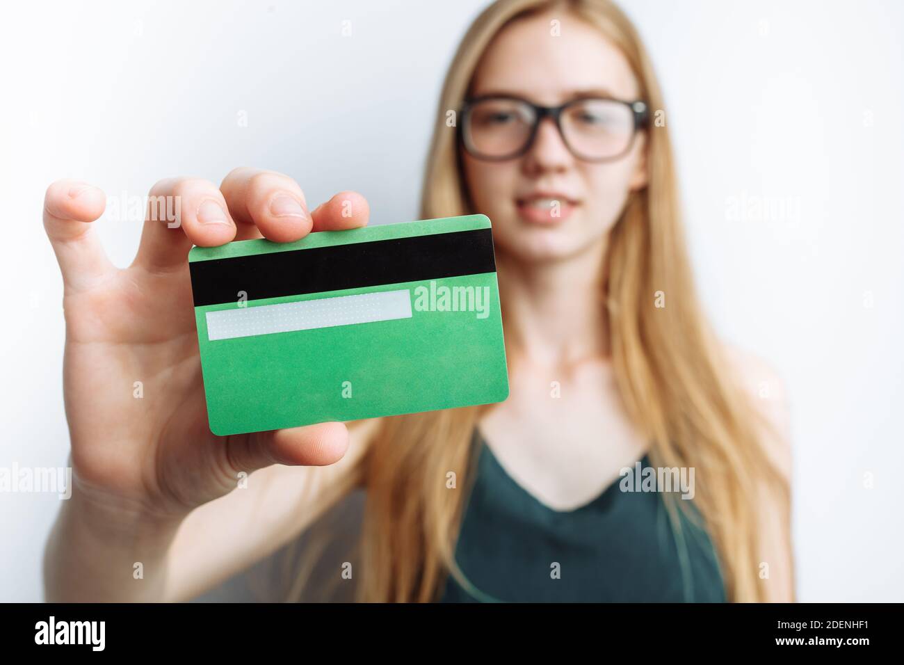 Beautiful girl shows Bank card, white background, advertising card ...