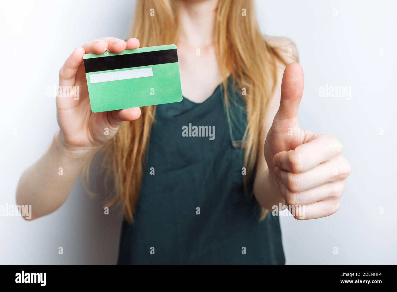 Beautiful girl shows Bank card, white background, advertising card ...