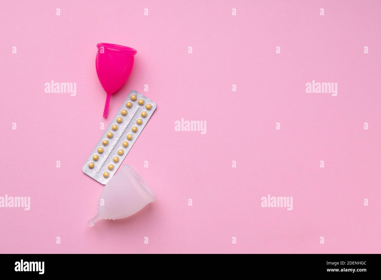Menstrual cup and oral contraceptive pills top view Stock Photo - Alamy