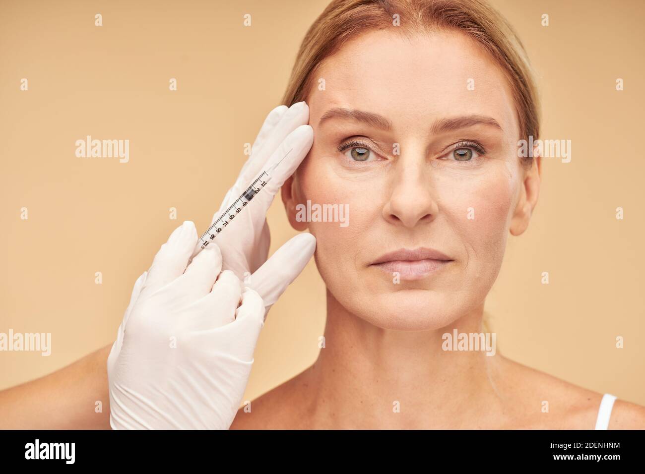 Anti aging procedures. Beautiful mature woman receiving hyaluronic acid ...