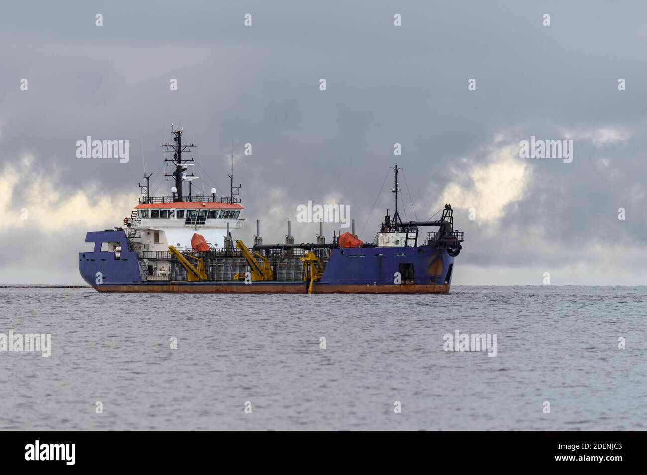 Vessel engaged in dredging. Dredger working at sea. Ship excavating ...