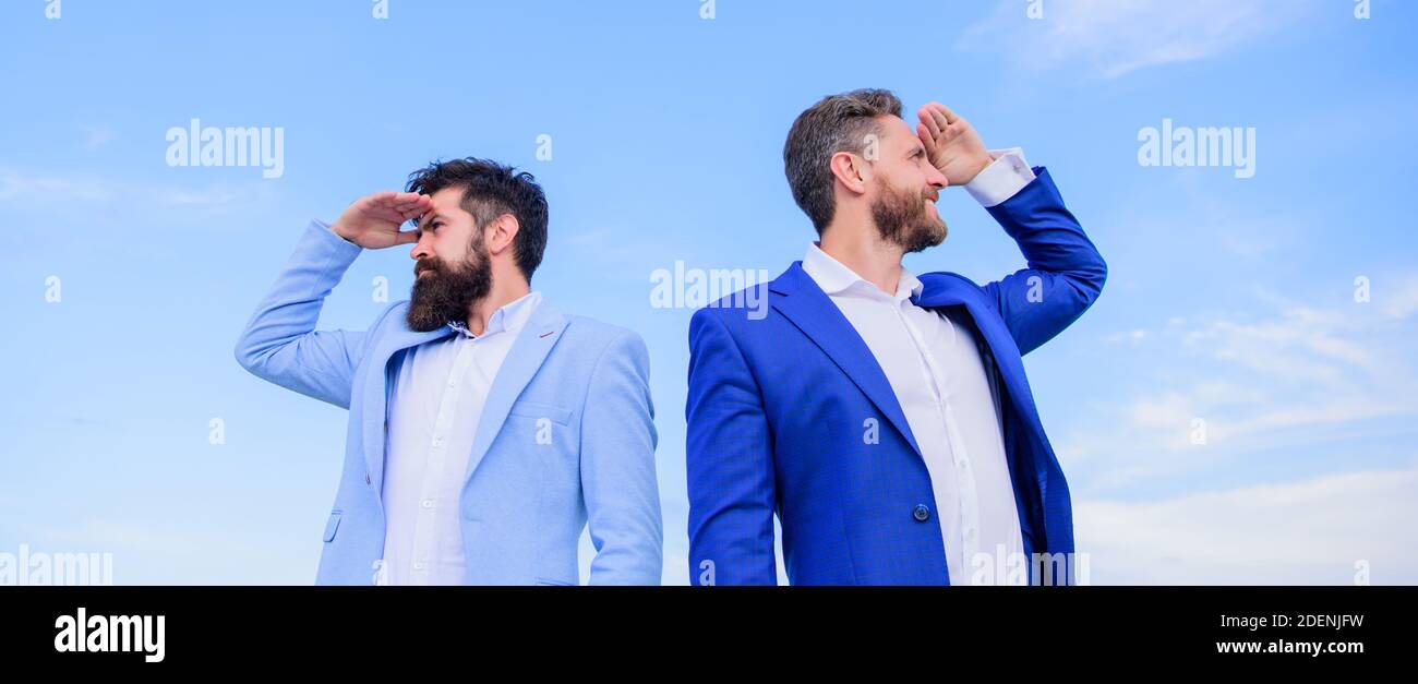 Changing course. Men formal suit managers looking at opposite ...