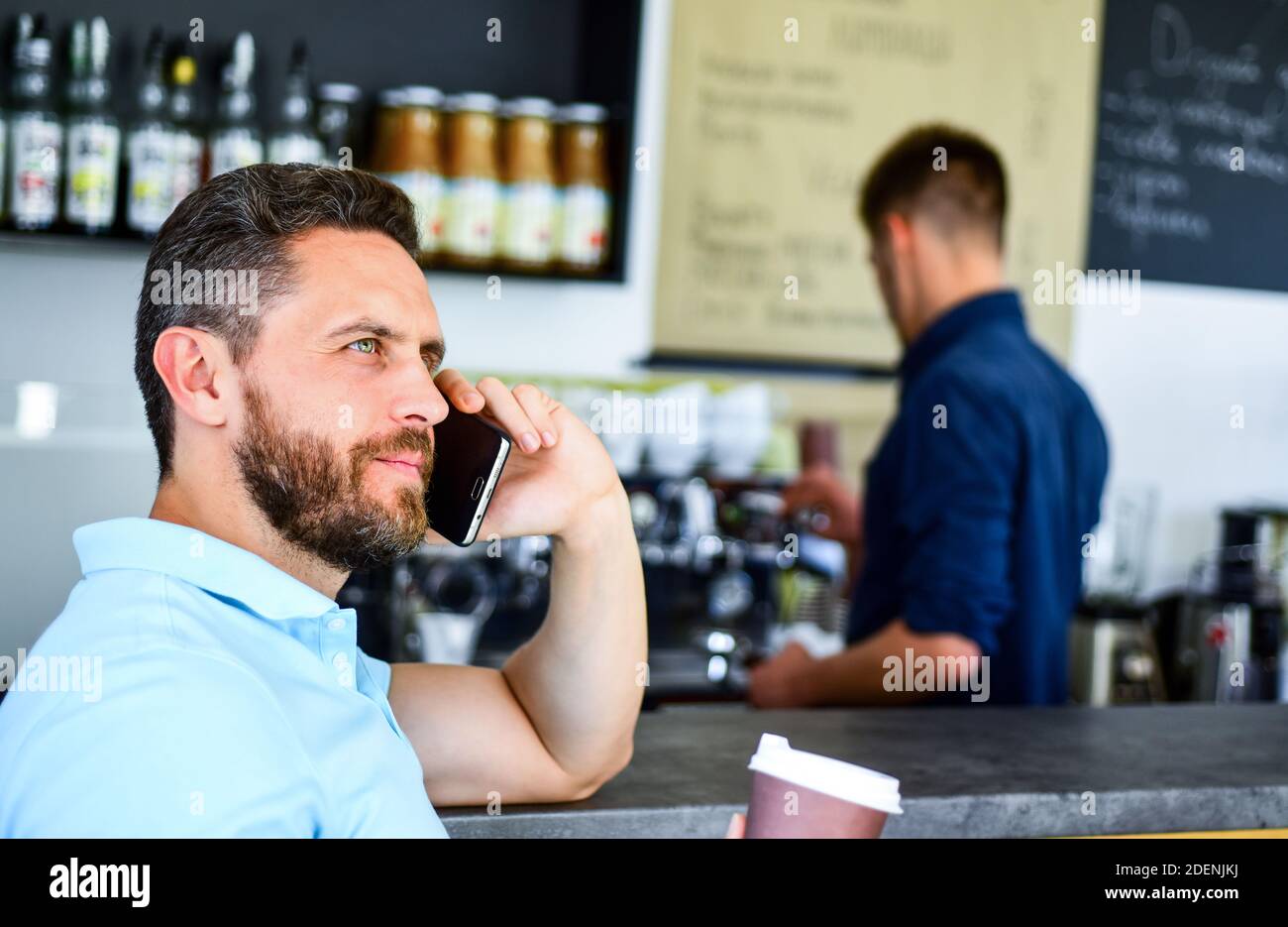 Drink coffee while waiting. Man smartphone order coffee in cafe. Coffee ...