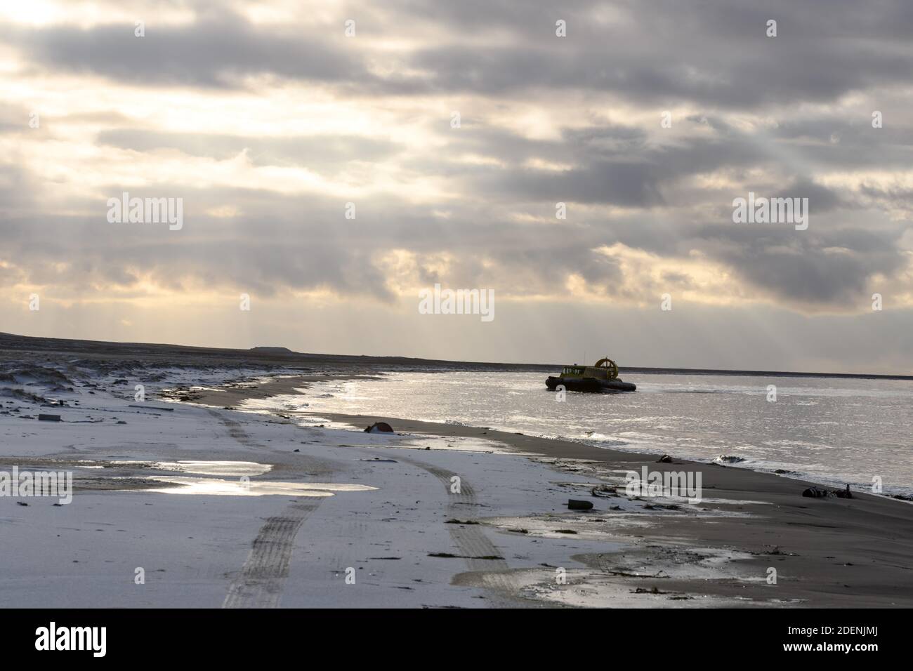 Hovercraft flying above water. Air cushion sailing near beach. Yellow ...