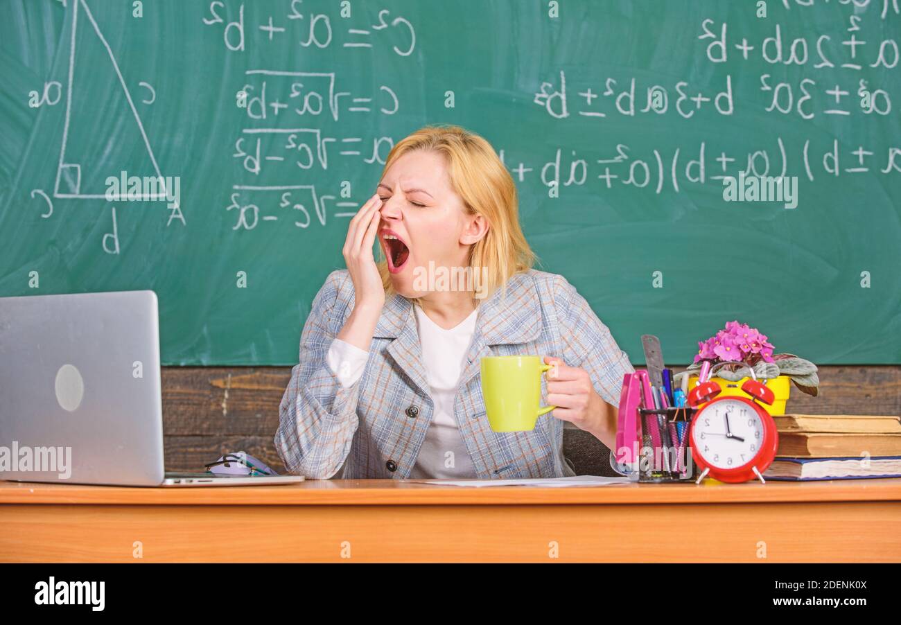 Workaholic sleepy at workplace. Teacher woman sit table classroom ...